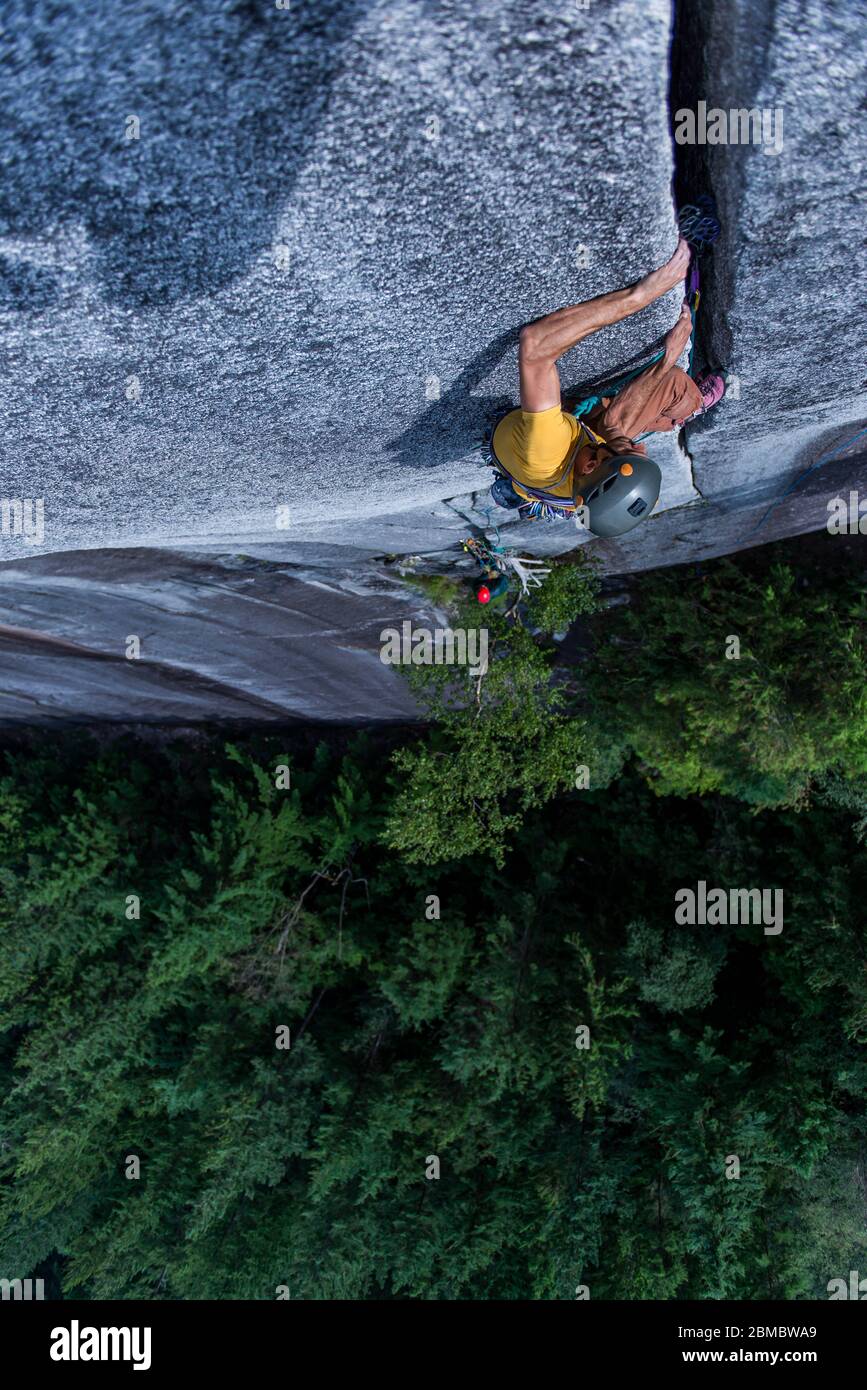 Man lay backing a wide crack high above ground on granite Squamish ...