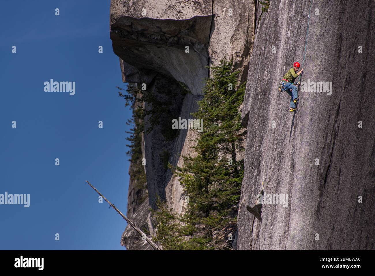 Man rock climbing big granite blank rock face in Squamish Chief BC ...