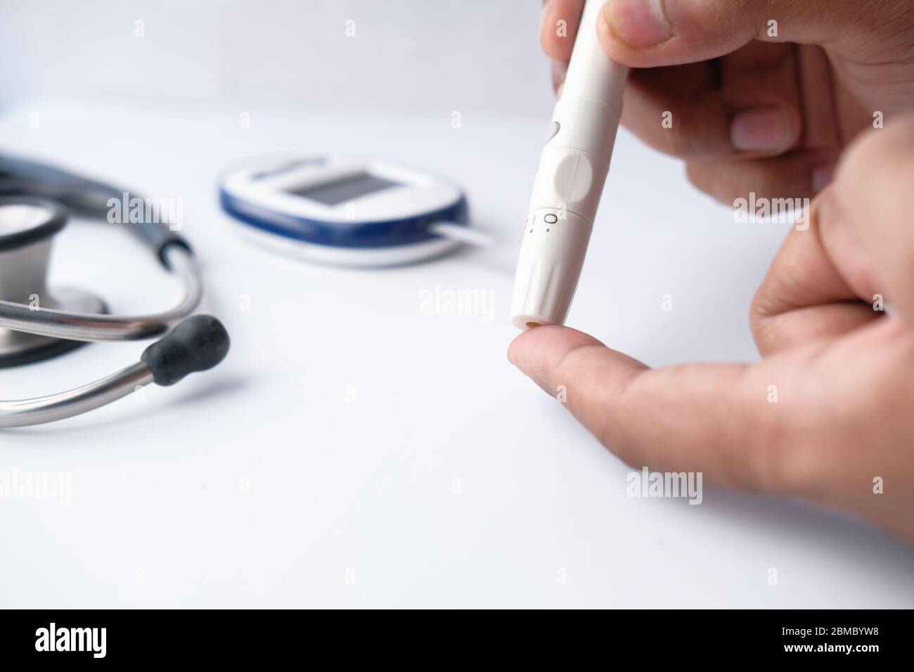 Checking blood glucose finger hi-res stock photography and images - Alamy
