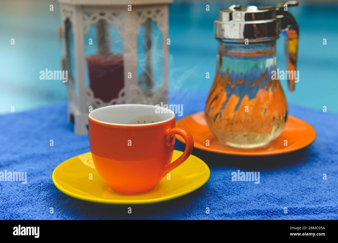 Hot espresso coffee serve on hotel swimming pool relax table with ...