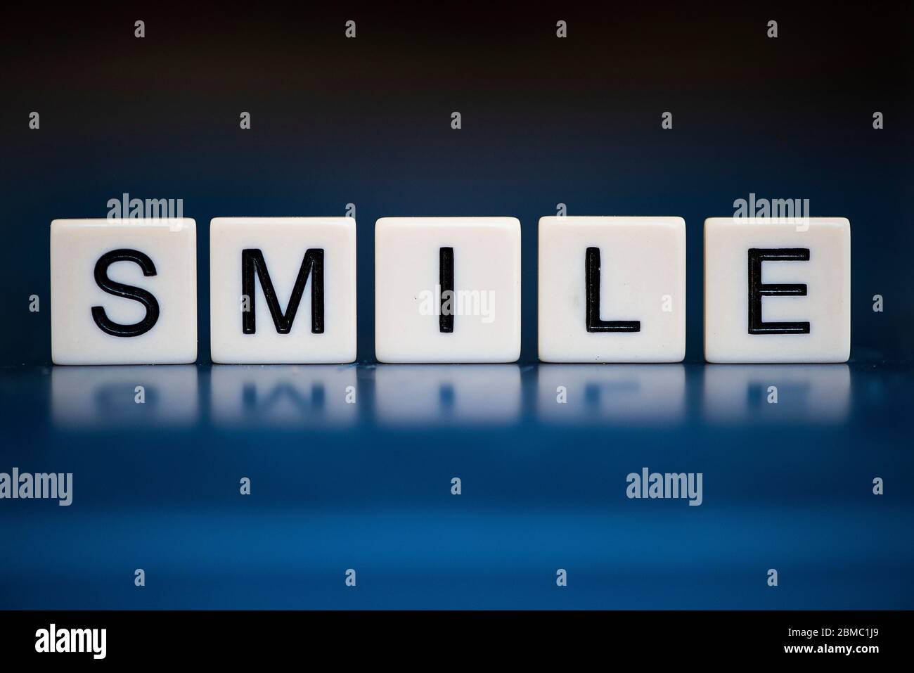 Smile in block letters Stock Photo - Alamy