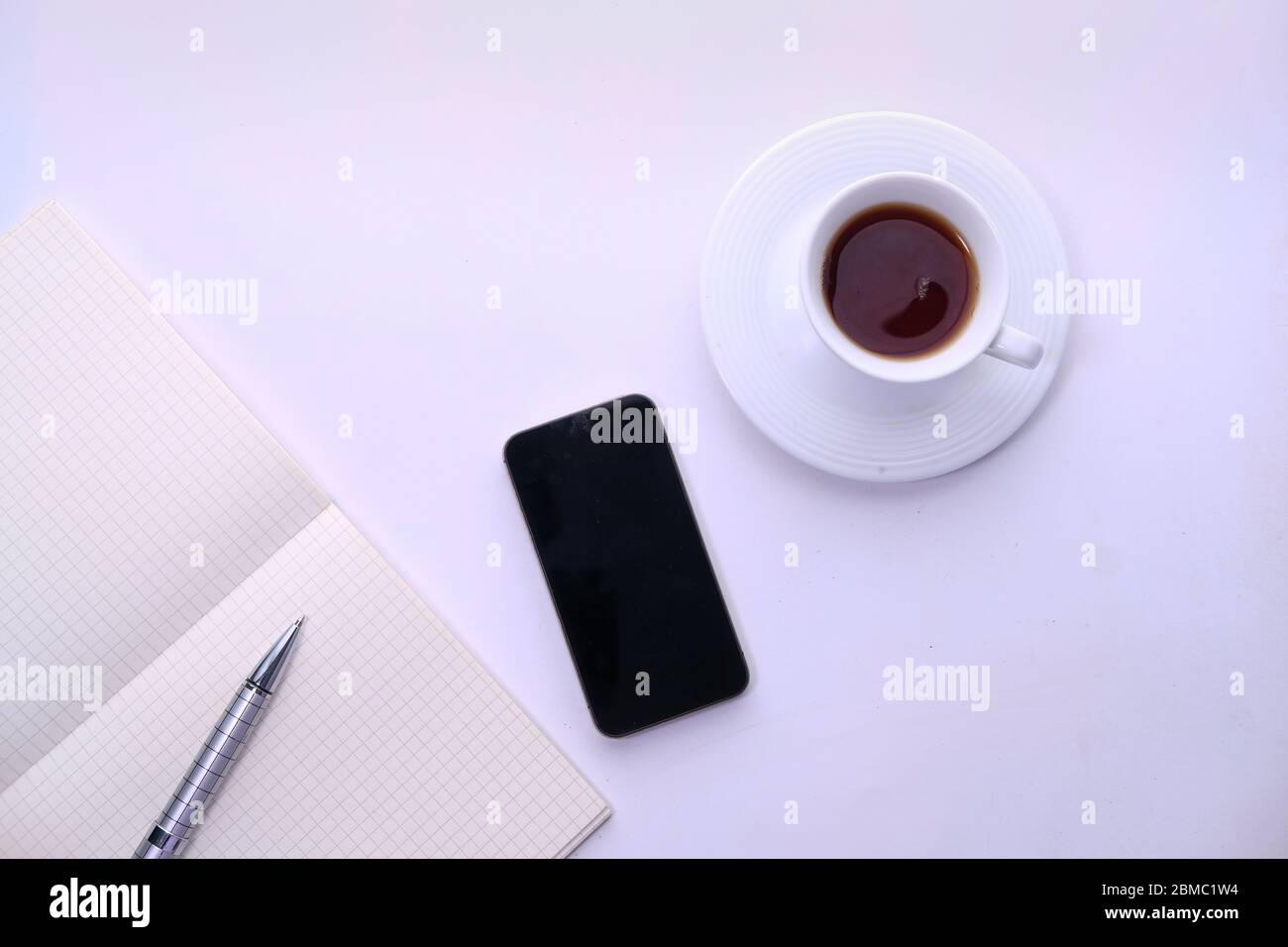 smart phone, notepad and tea on white background Stock Photo - Alamy