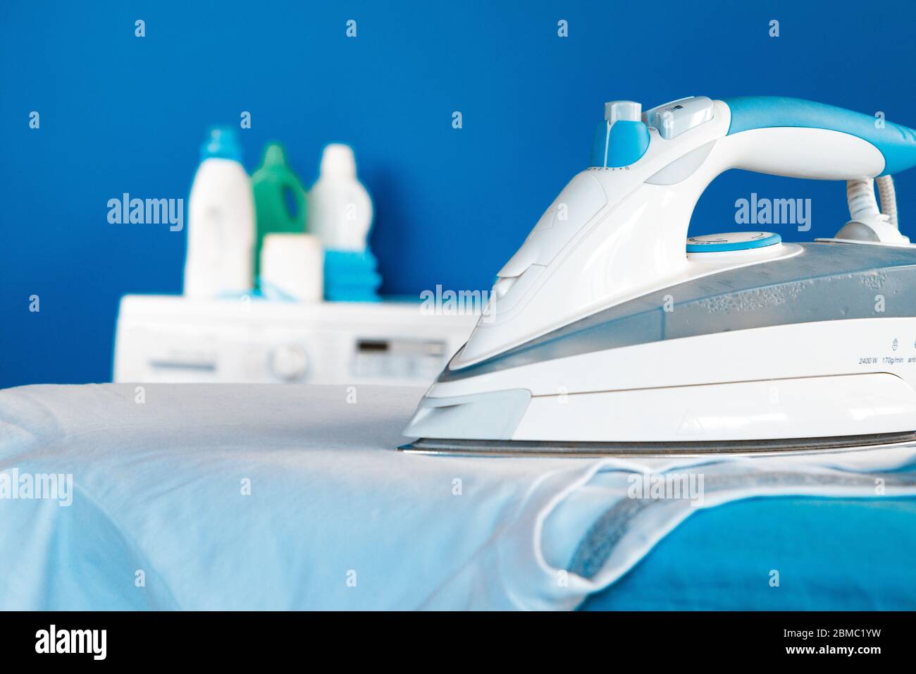 Housekeeping concept. Washing machine and ironing board Stock Photo - Alamy