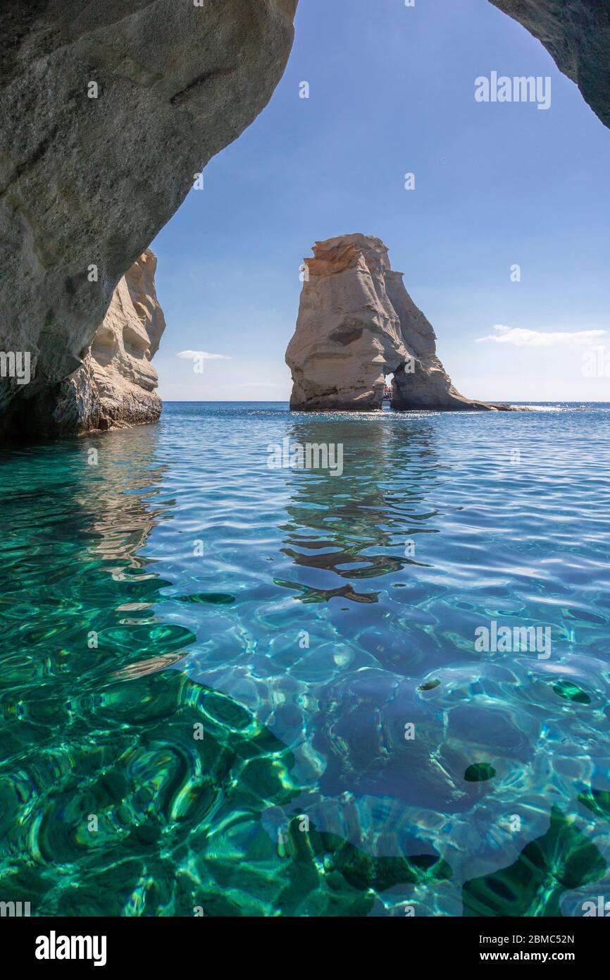 View through a sea cave towards a sea stack at Kleftiko, Milos ...
