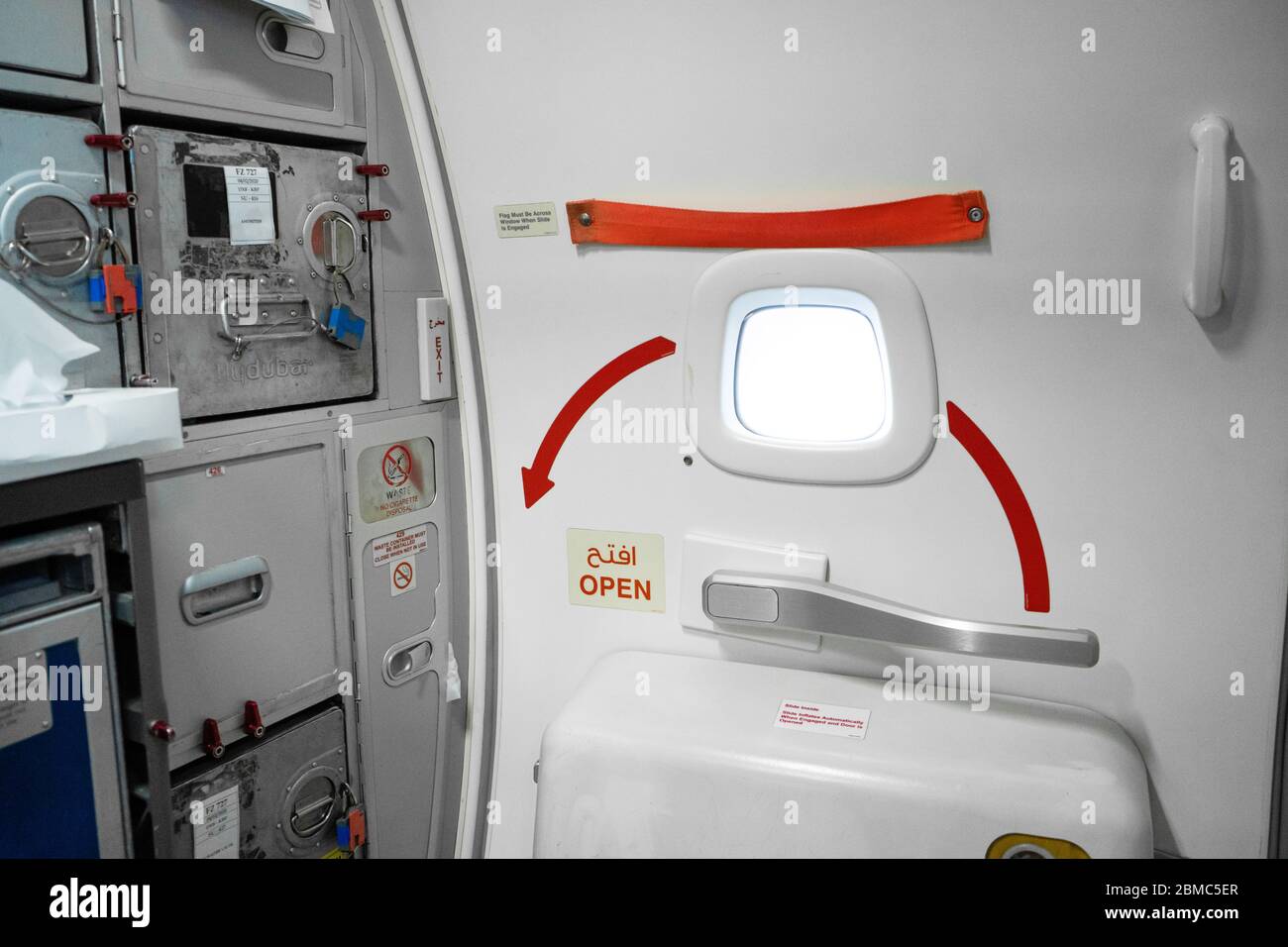 Emergency exit door in an airplane Stock Photo - Alamy