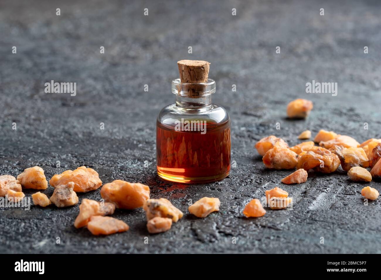 A bottle of styrax benzoin essential oil with resin, with copy space ...