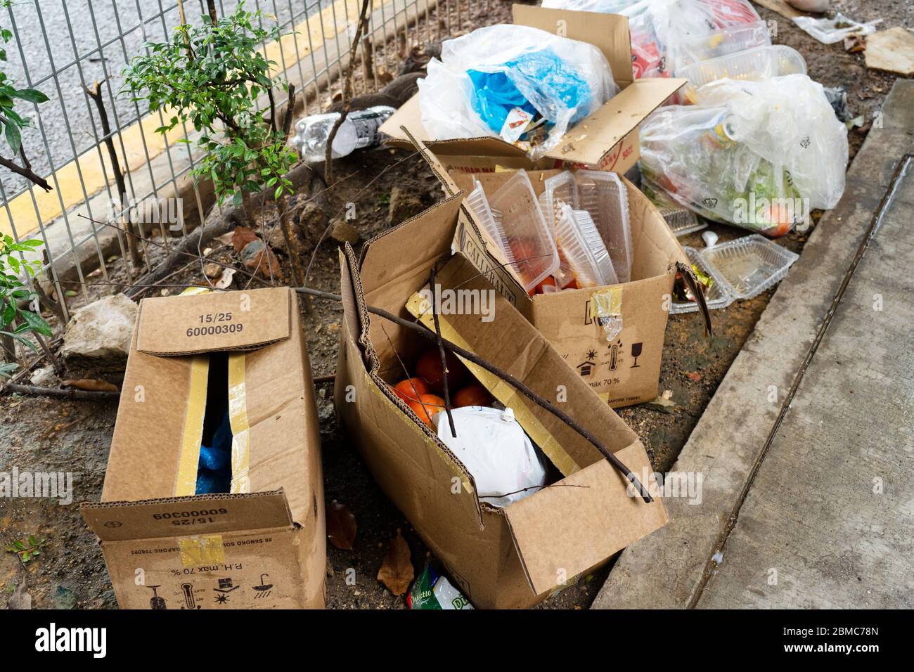 Mountain of garbage and cardboard boxes on the street. The problem of ...