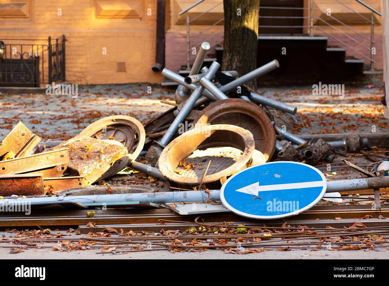Reconstruction of the city street. Pile of materials, road signs and ...