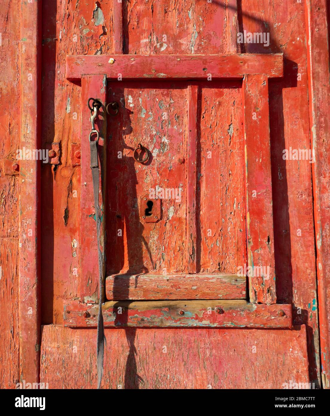 A rustic red window in a door at Klima Fishing Village - Milos Island ...