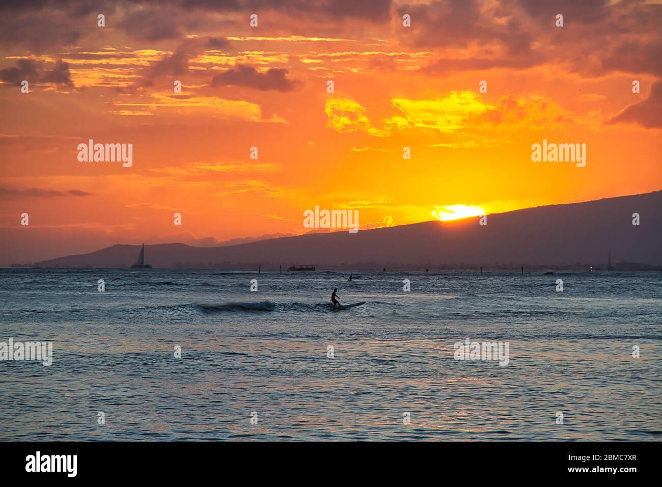 Solo Surfing at Sunset Stock Photo - Alamy