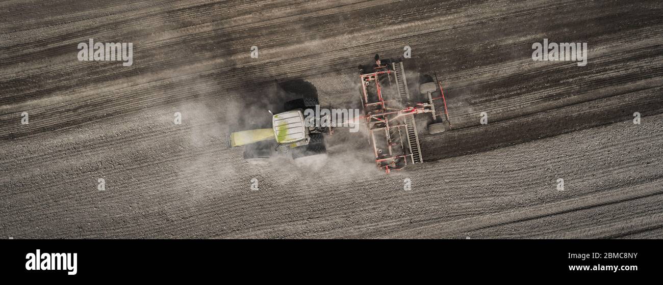 Aerial view of a clean field in which the tractor makes vertical ...