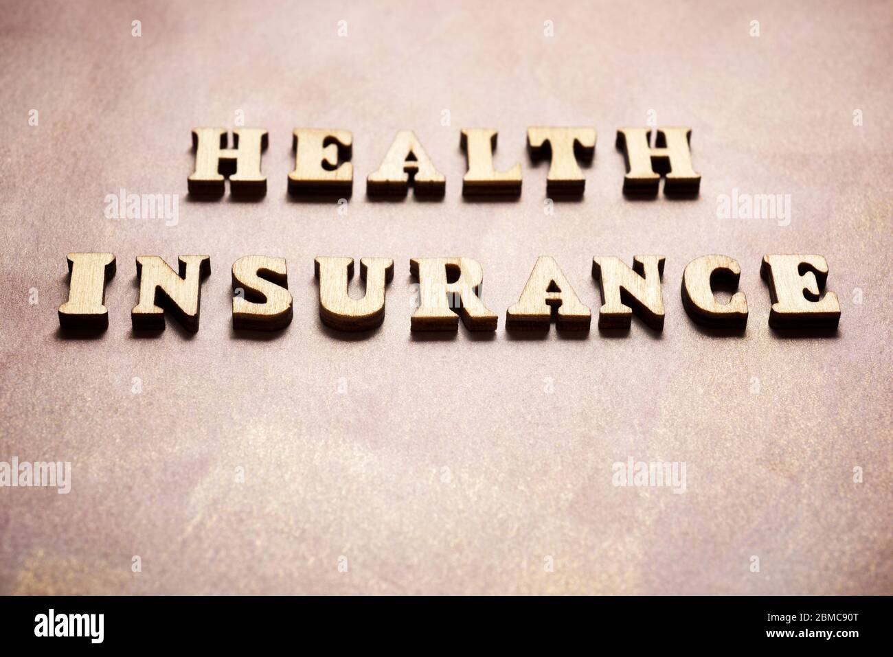 Health insurance text on a colored paper Stock Photo - Alamy