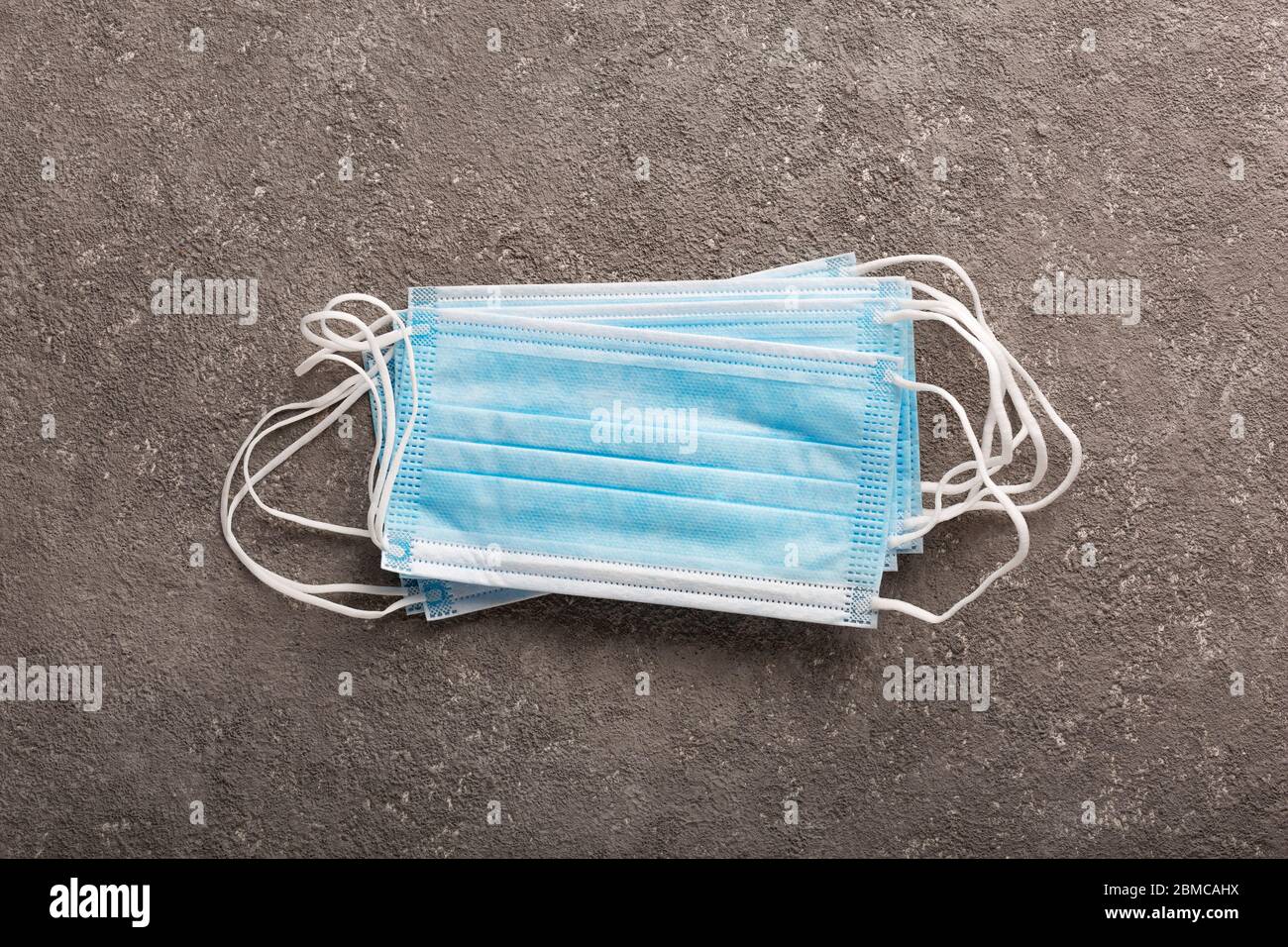 Blue medical face masks on concrete background, Second wave, Personal ...