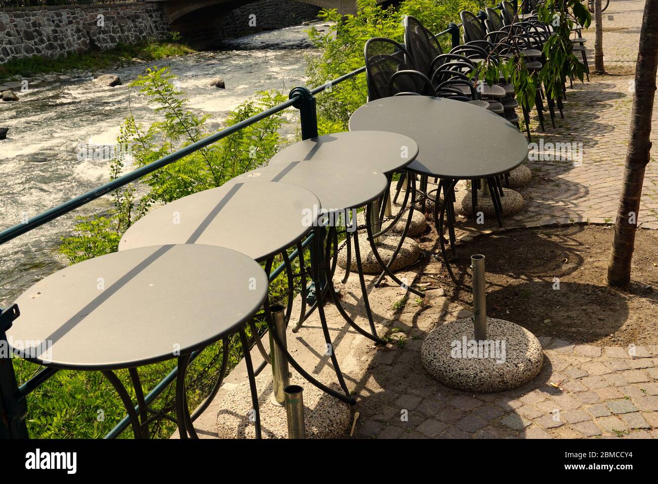 Tables and chairs of a restaurant stacked and chained together. Last ...