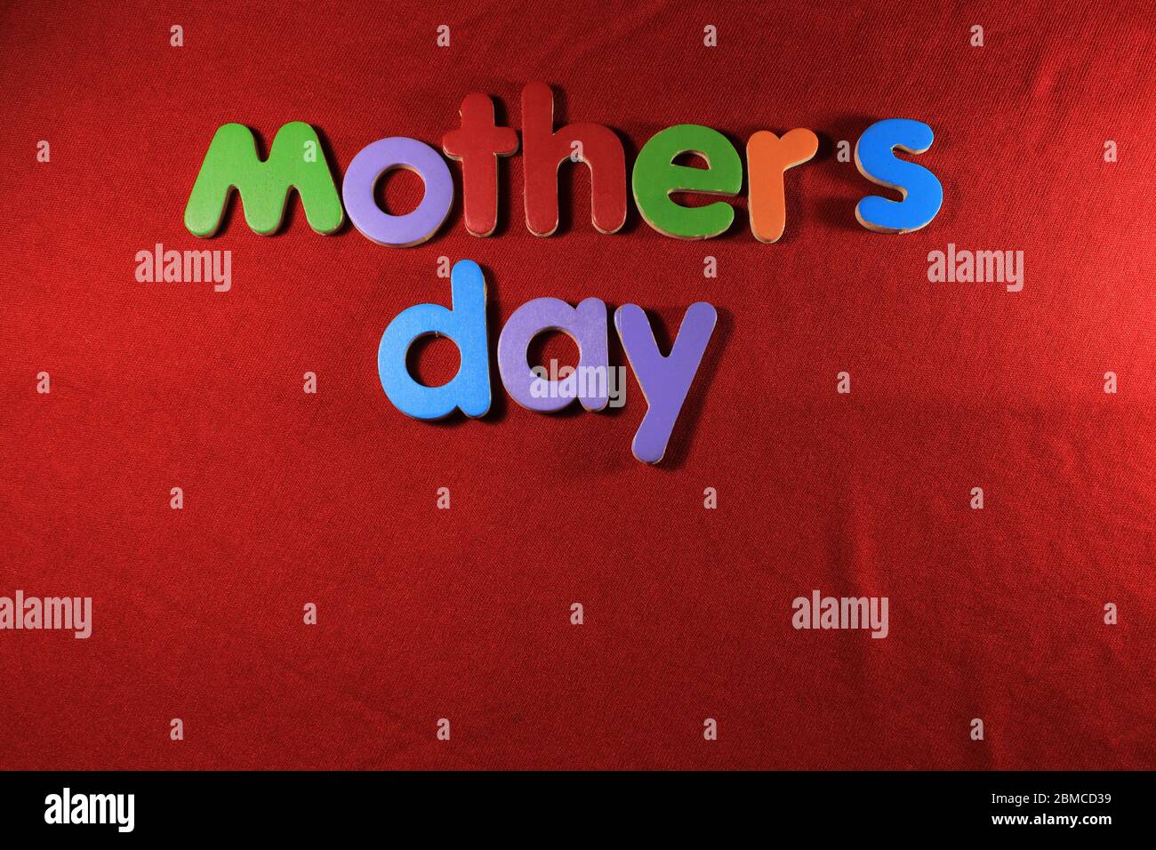 Mother's Day written by colorful alphabet blocks arranged on red ...