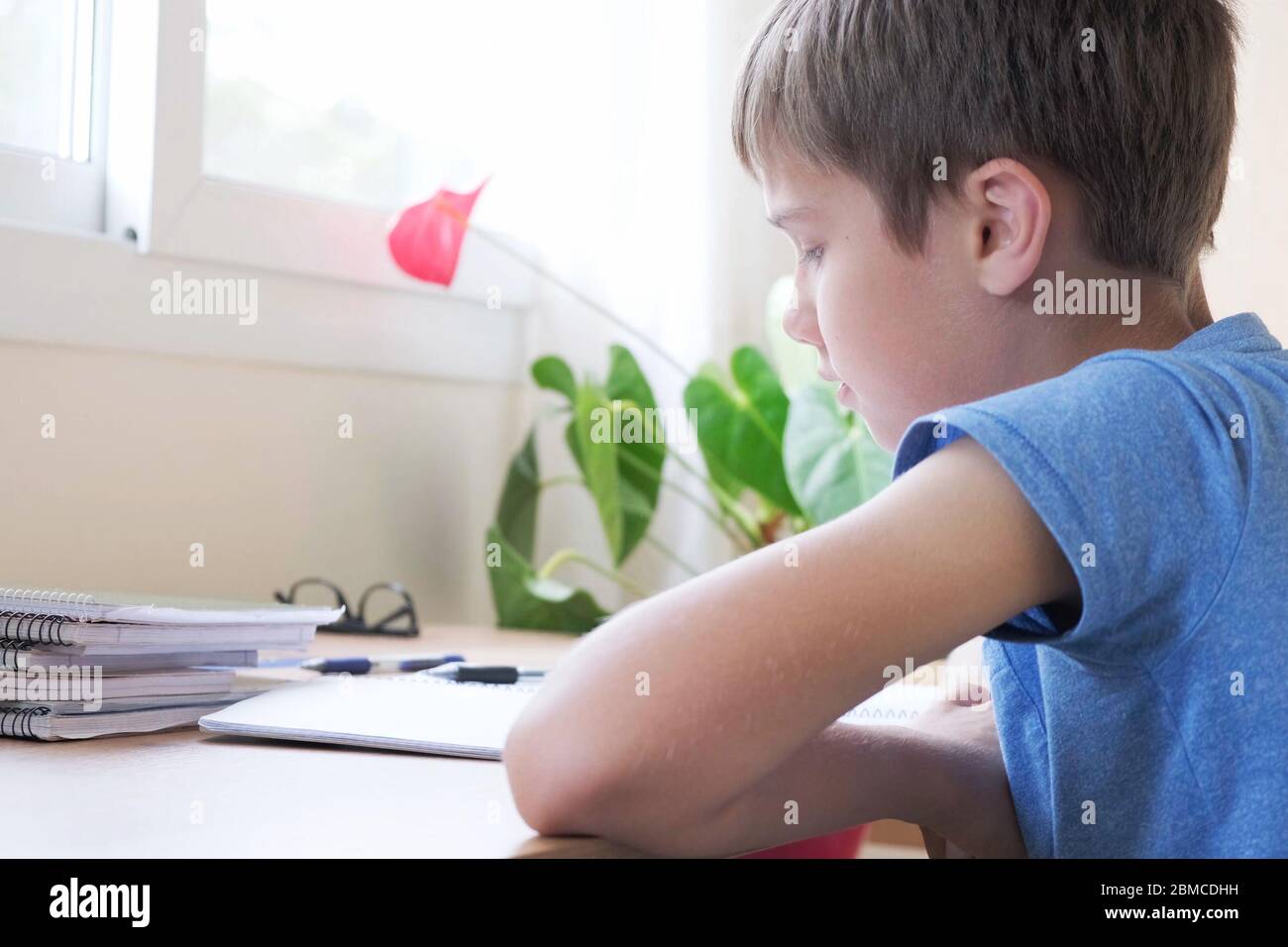 Kid doing homework task at home. Online learning, homeschooling ...