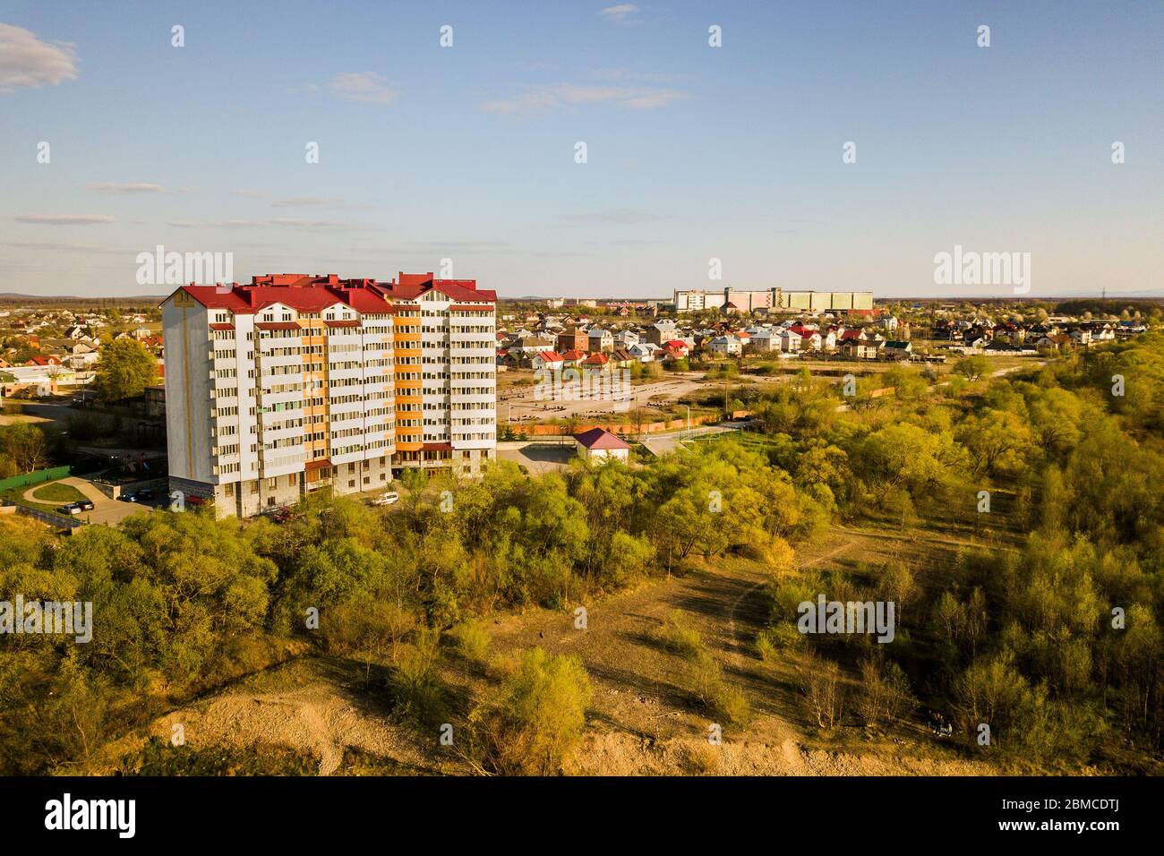 Aerial view of high residential apartment building in green rural area ...