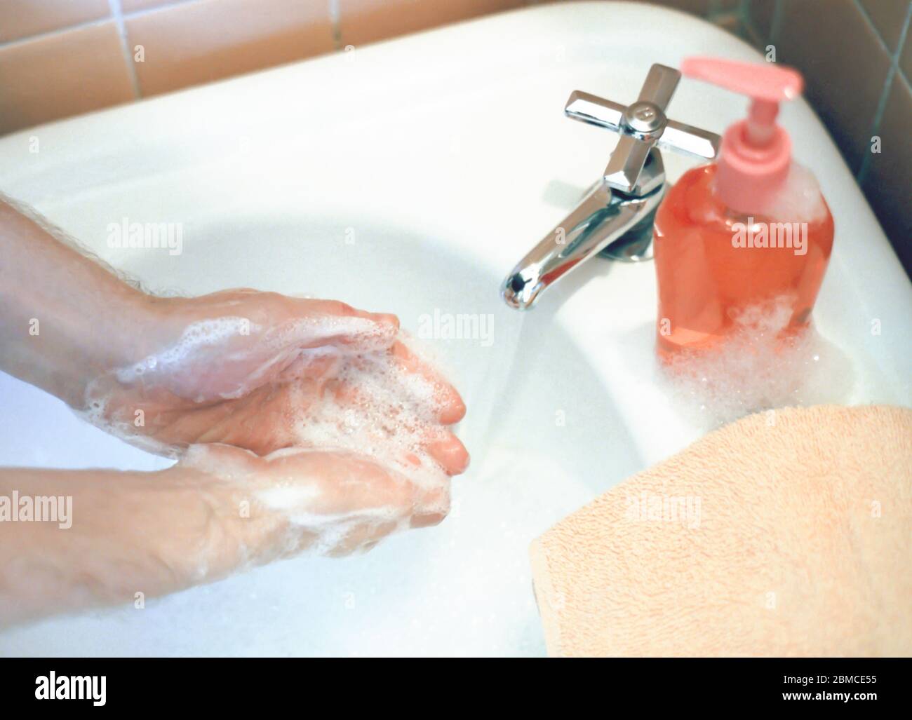Man washing hands. Frequent hand washing recommended to reduce the risk ...