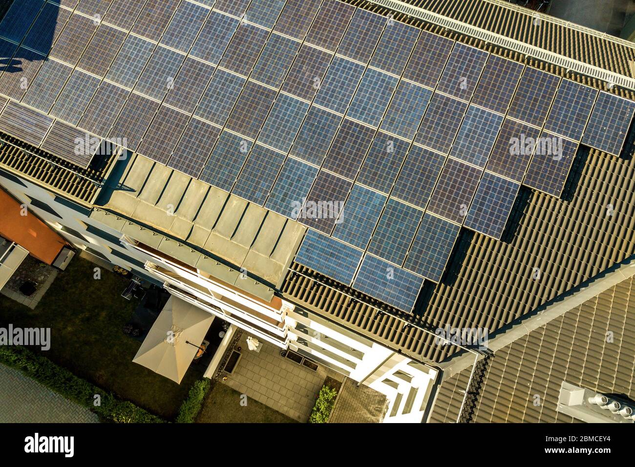 Aerial view of solar photovoltaic panels on a roof top of residential ...