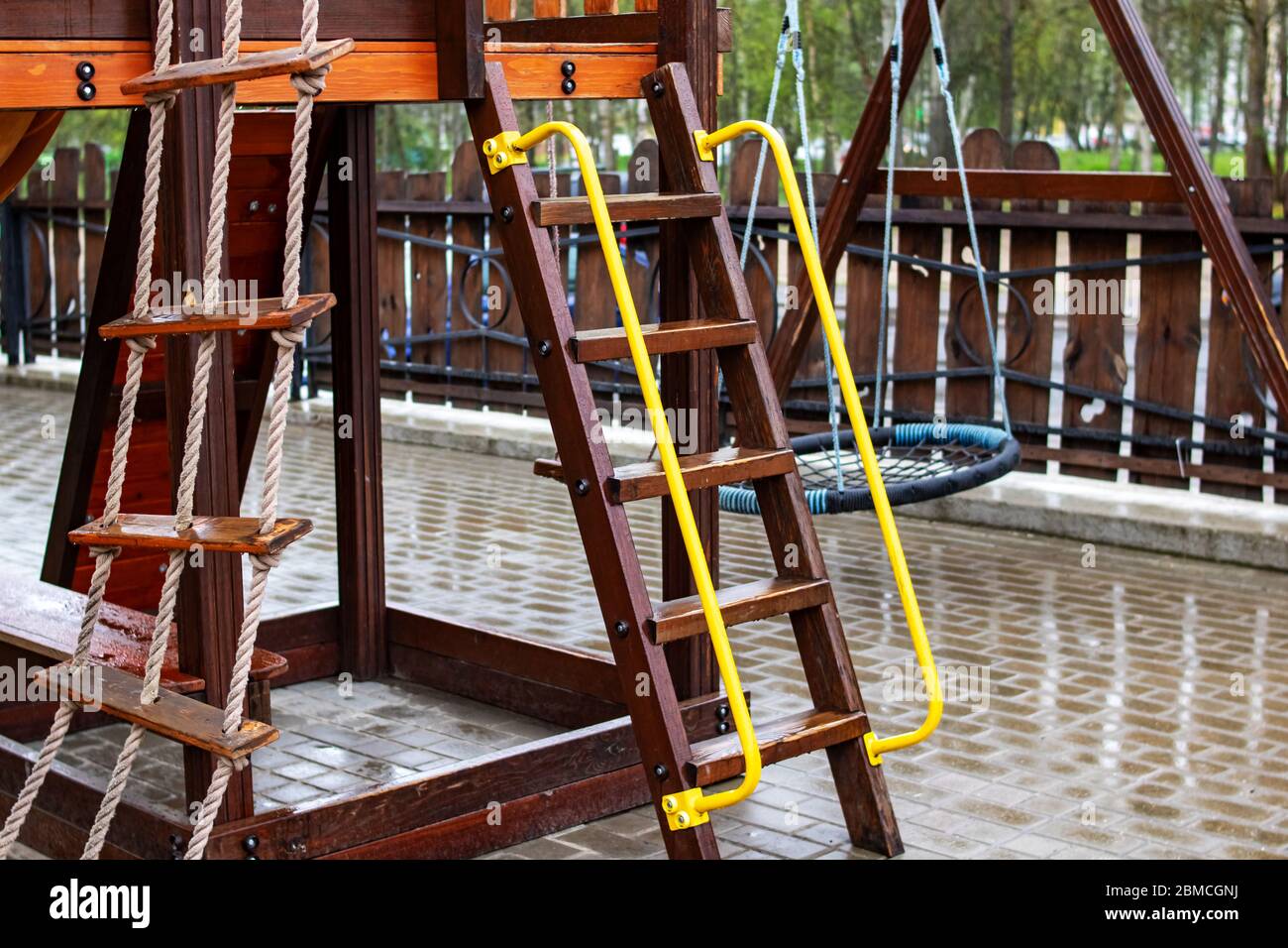 Wooden stairs in playground wet in rain Stock Photo - Alamy