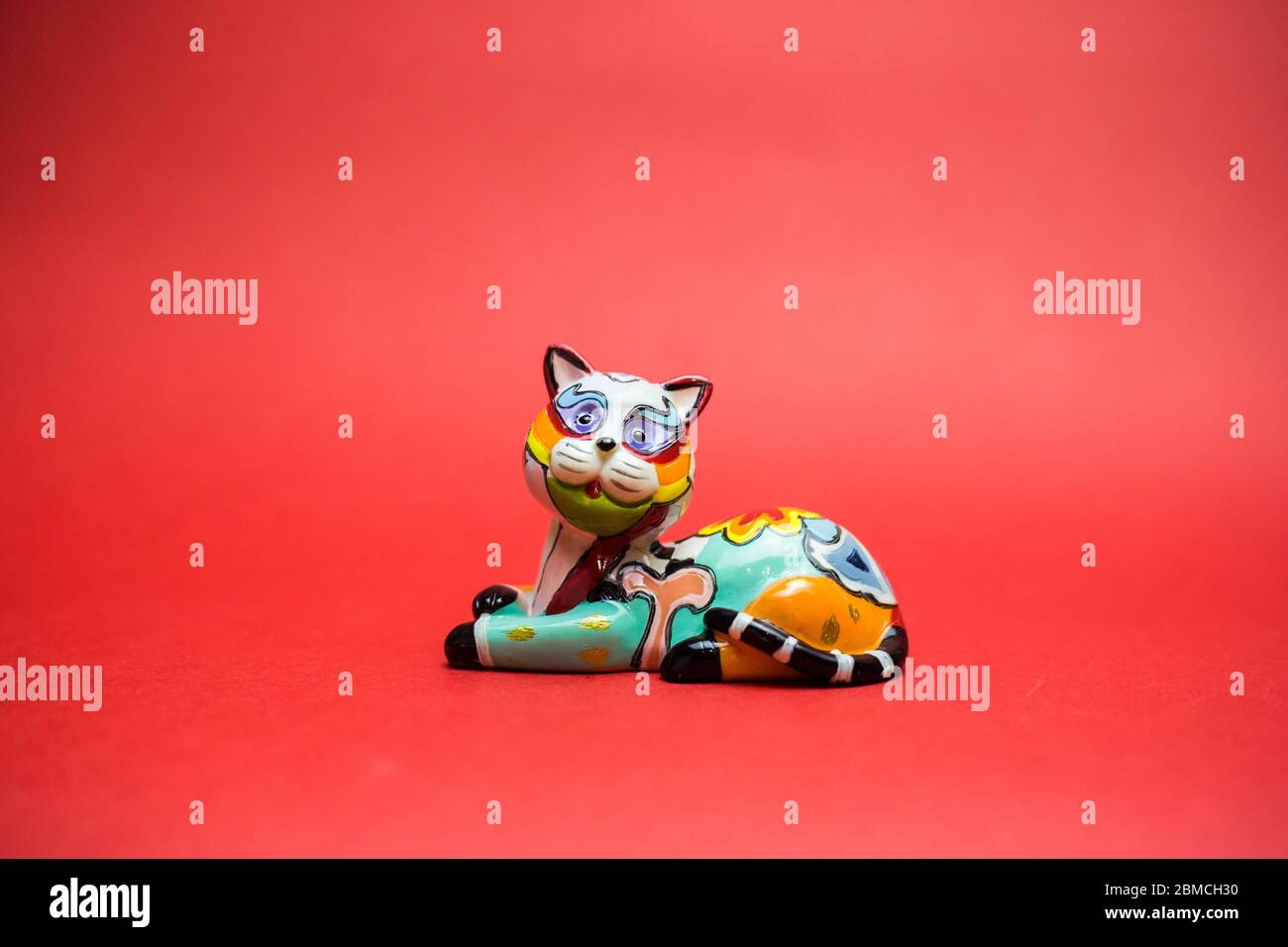 Figurine multi-colored cat Stock Photo - Alamy