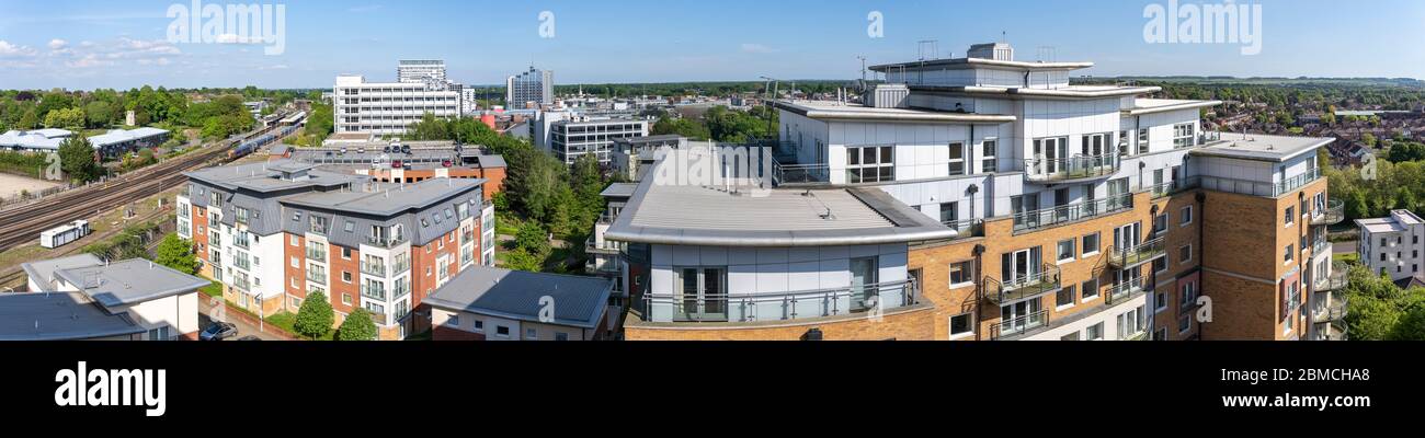 An aerial panorama view across Basingstoke town centre: railway station ...