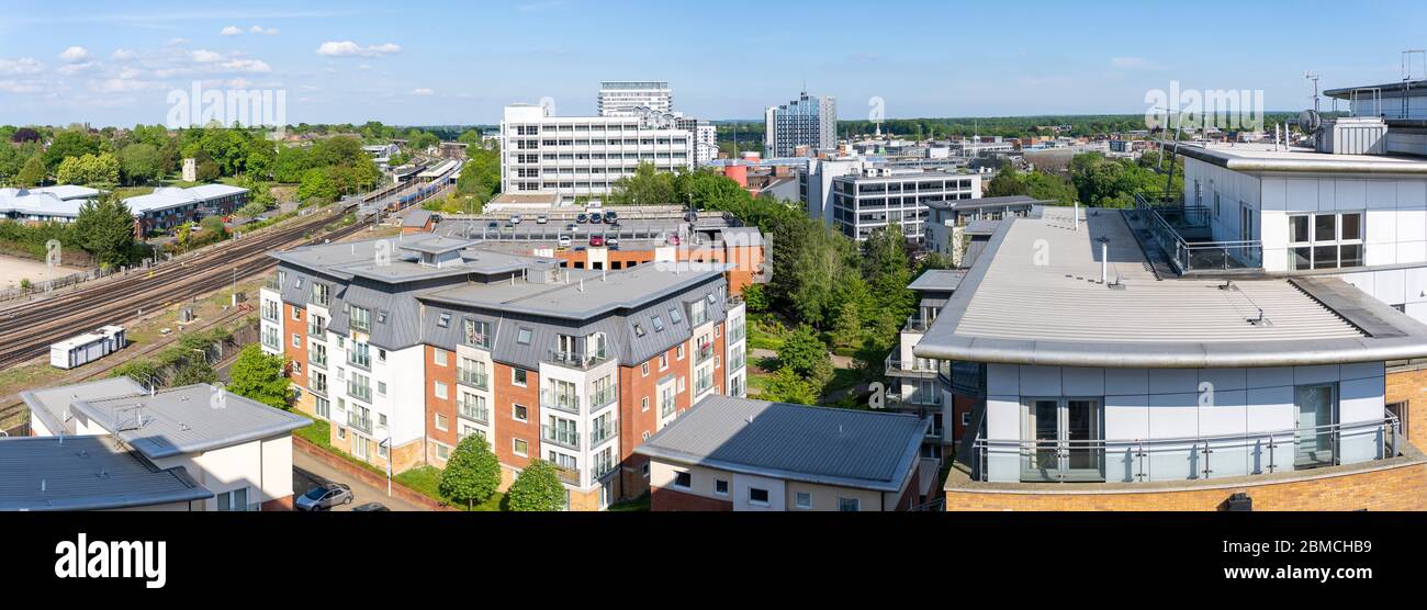 A summer aerial panorama view across Basingstoke town centre: railway ...
