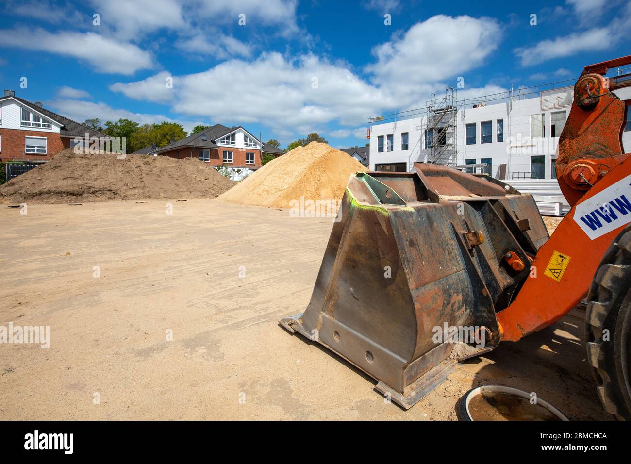 an orange wheel loader is on a construction site Stock Photo - Alamy