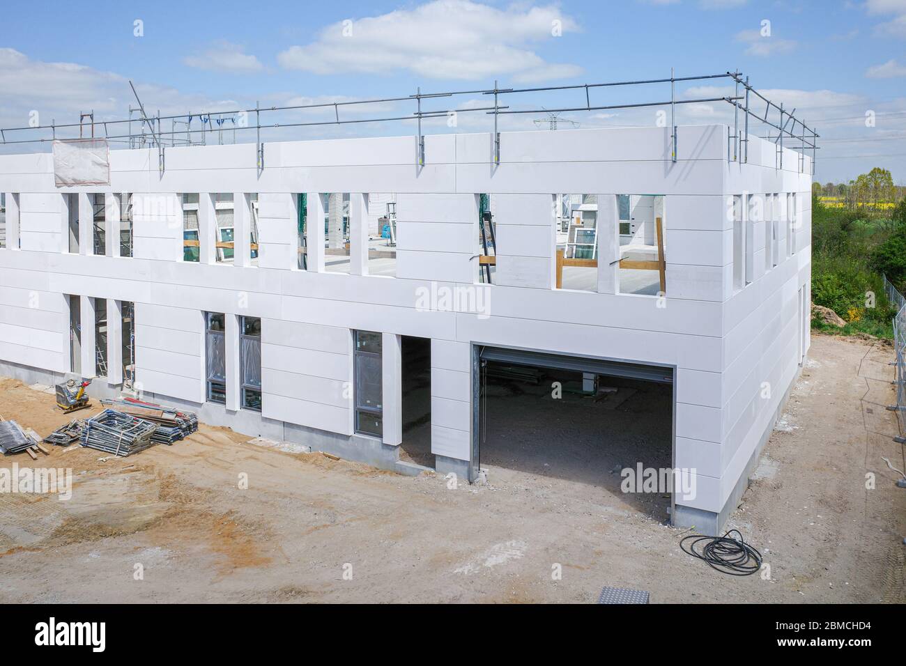 the outdoor shot of a building that is in the process of completion on ...