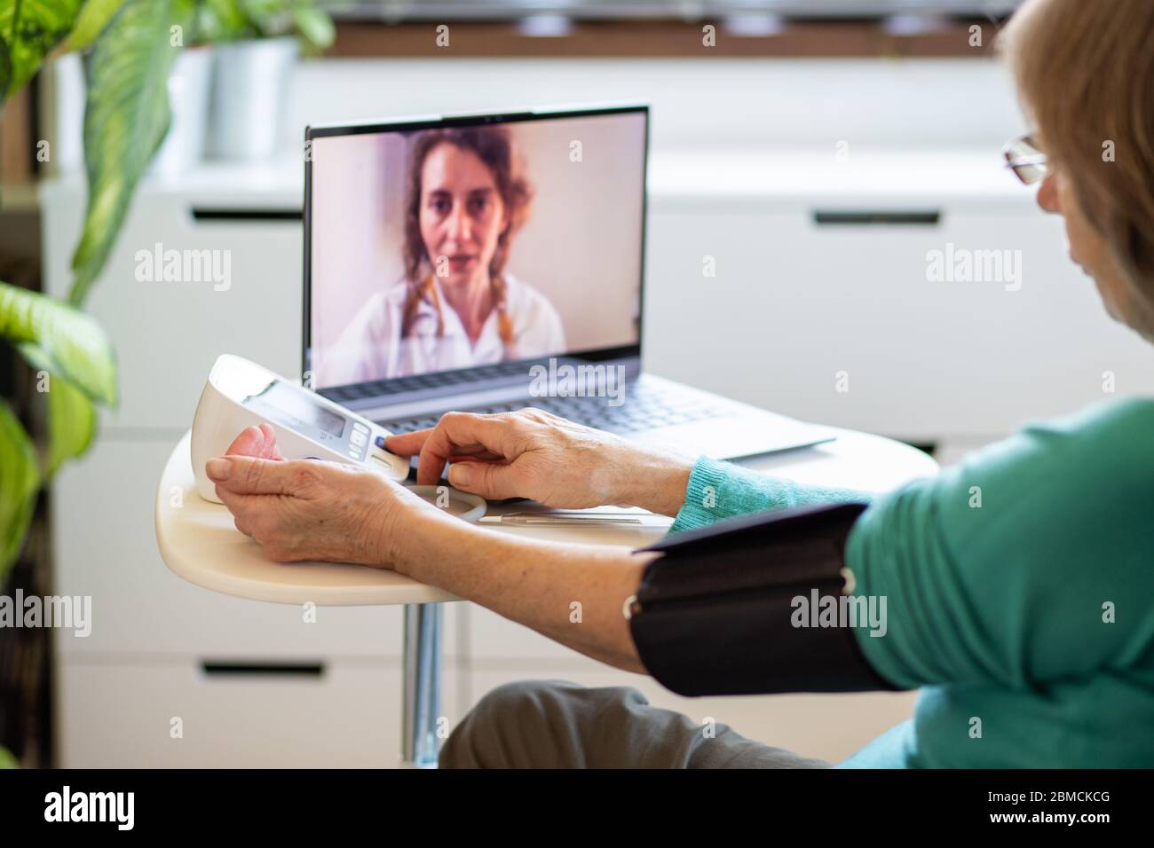 telemedicine concept elderly woman speaking to her doctor online and ...