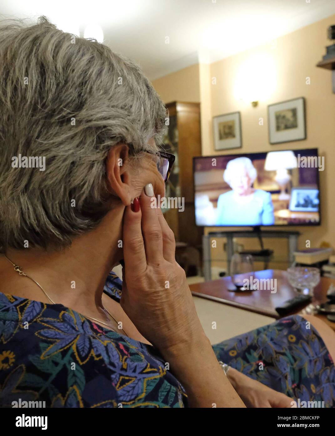 Caroline Hogan, 65, watches a pre-recorded speech by Queen Elizabeth II ...