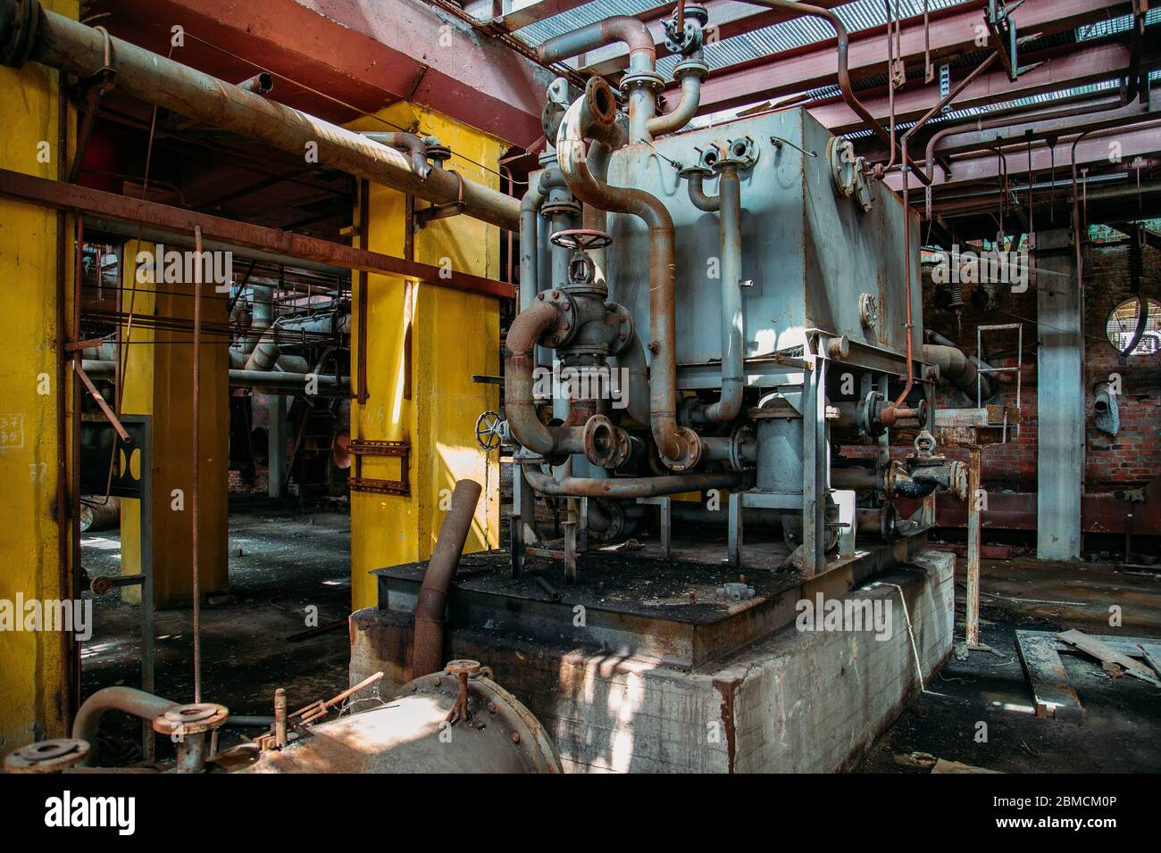 Old rusty Industrial tanks connected by pipes connected with valves in ...