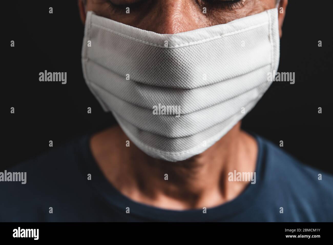 Elderly person wearing a mask to prevent the spread of the coronavirus ...