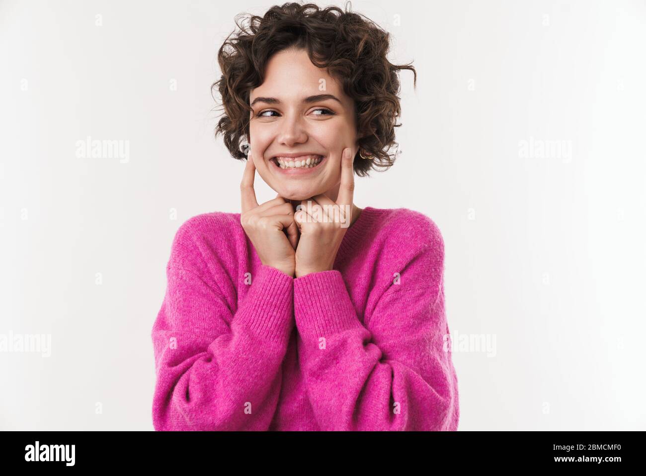 Image of happy caucasian woman smiling and pointing finger at her ...
