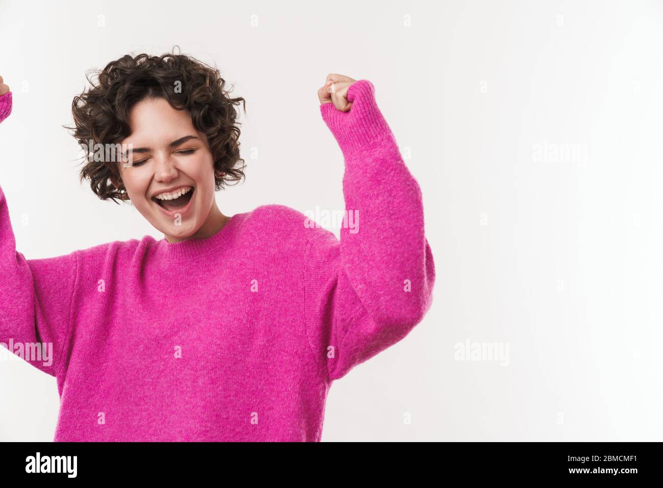 Image of excited beautiful woman smiling and dancing isolated over ...