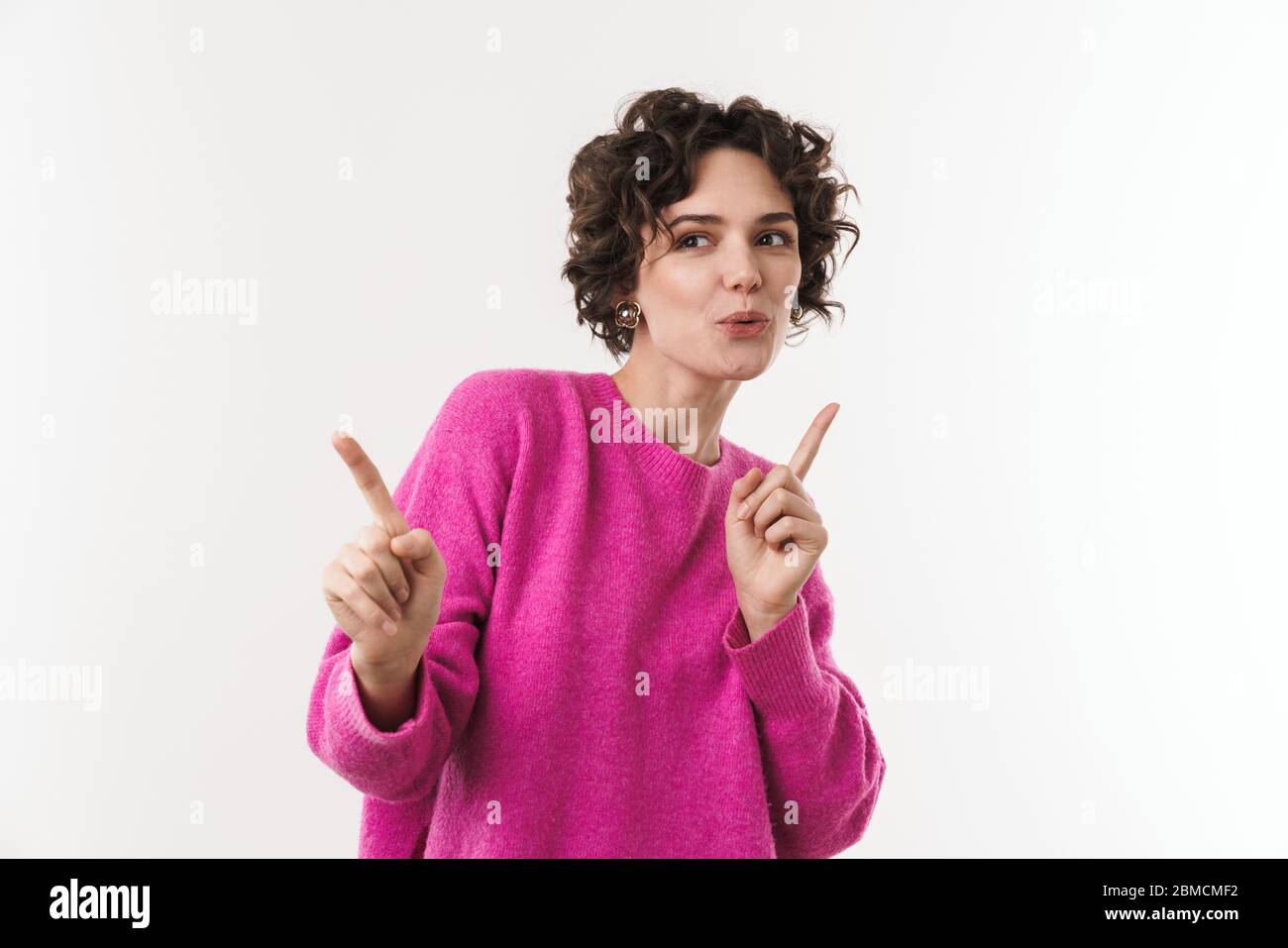 Image of happy beautiful woman pointing finger upward and dancing ...