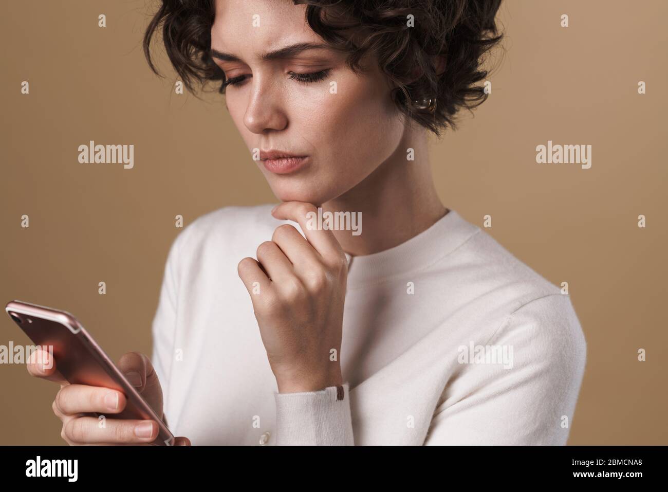 Image of brooding seductive woman using cellphone and thinking isolated ...