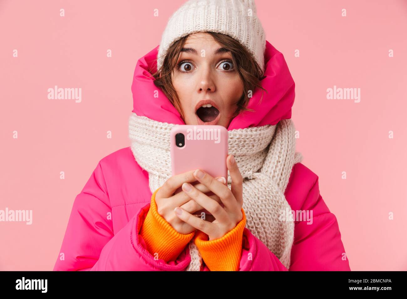 Portrait of beautiful woman in warm clothes expressing surprise and ...