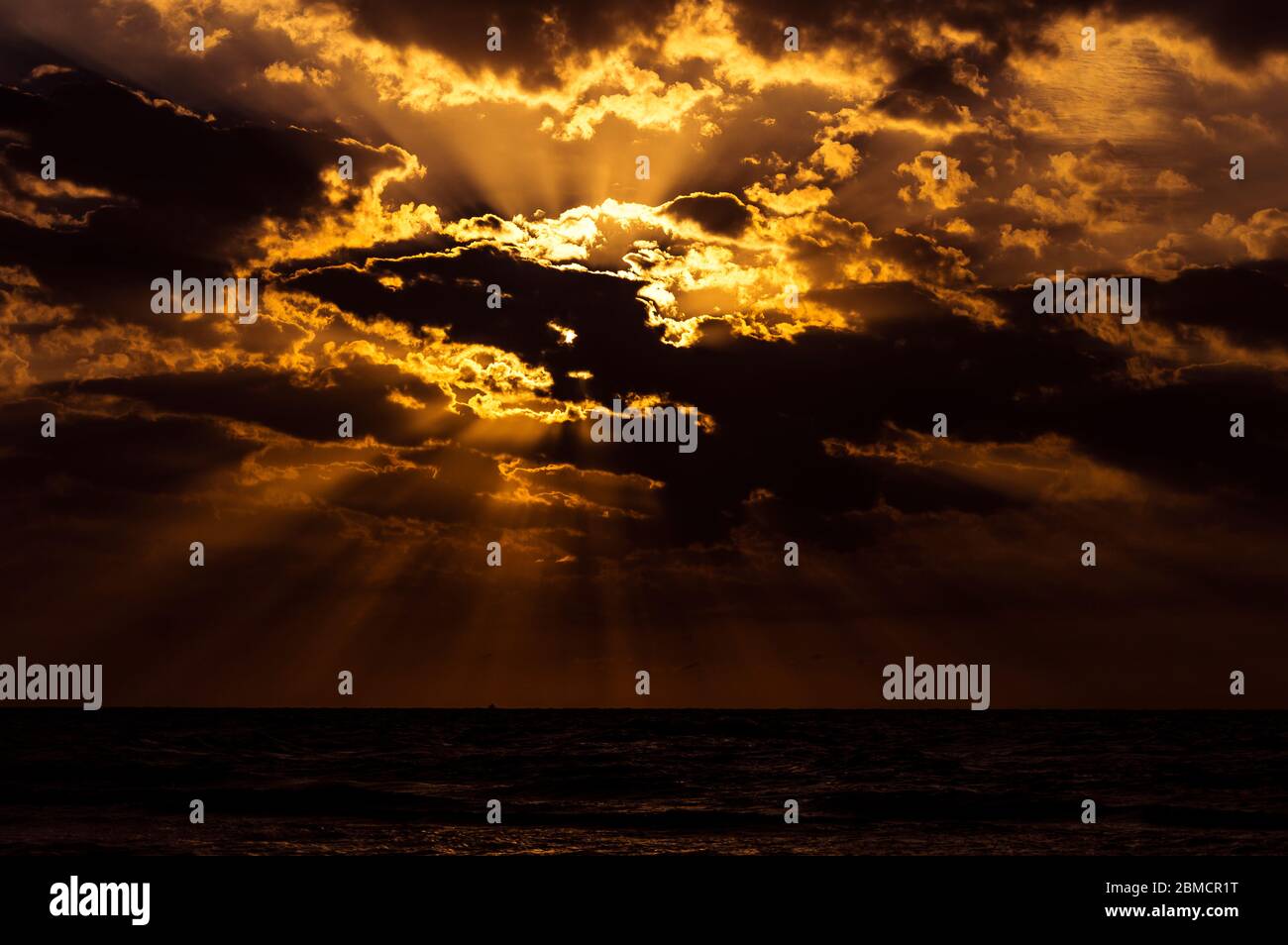 Golden hour of sunset at red sea shore with dramatic sky and the golden ...