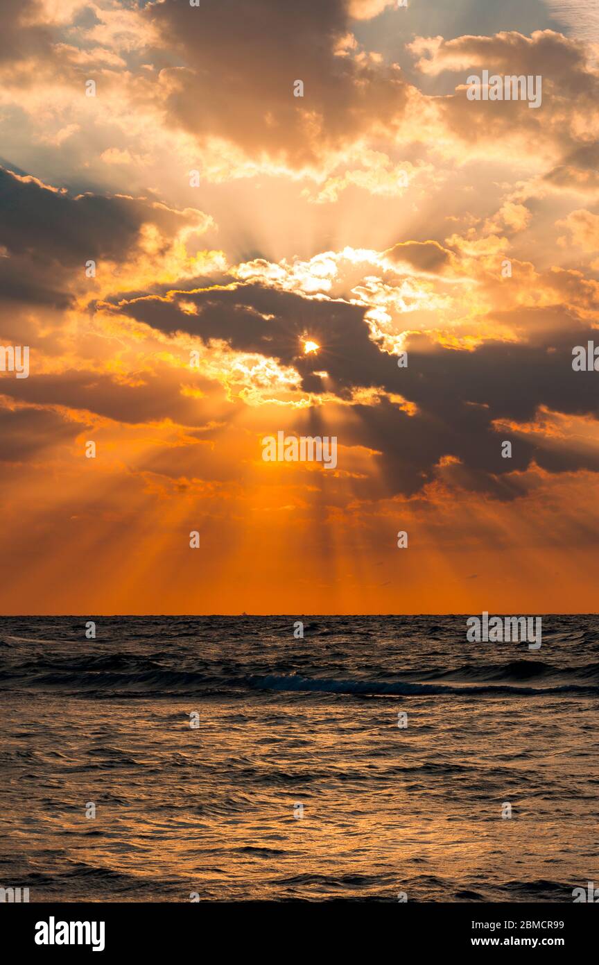Golden hour of sunset at red sea shore with dramatic sky and the golden ...