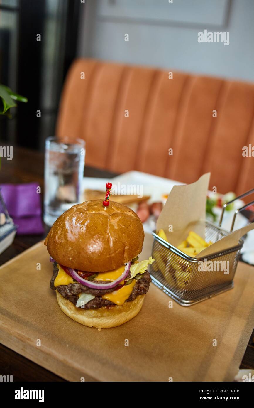 Dish presentation - traditional american burger with fries on a stylish ...