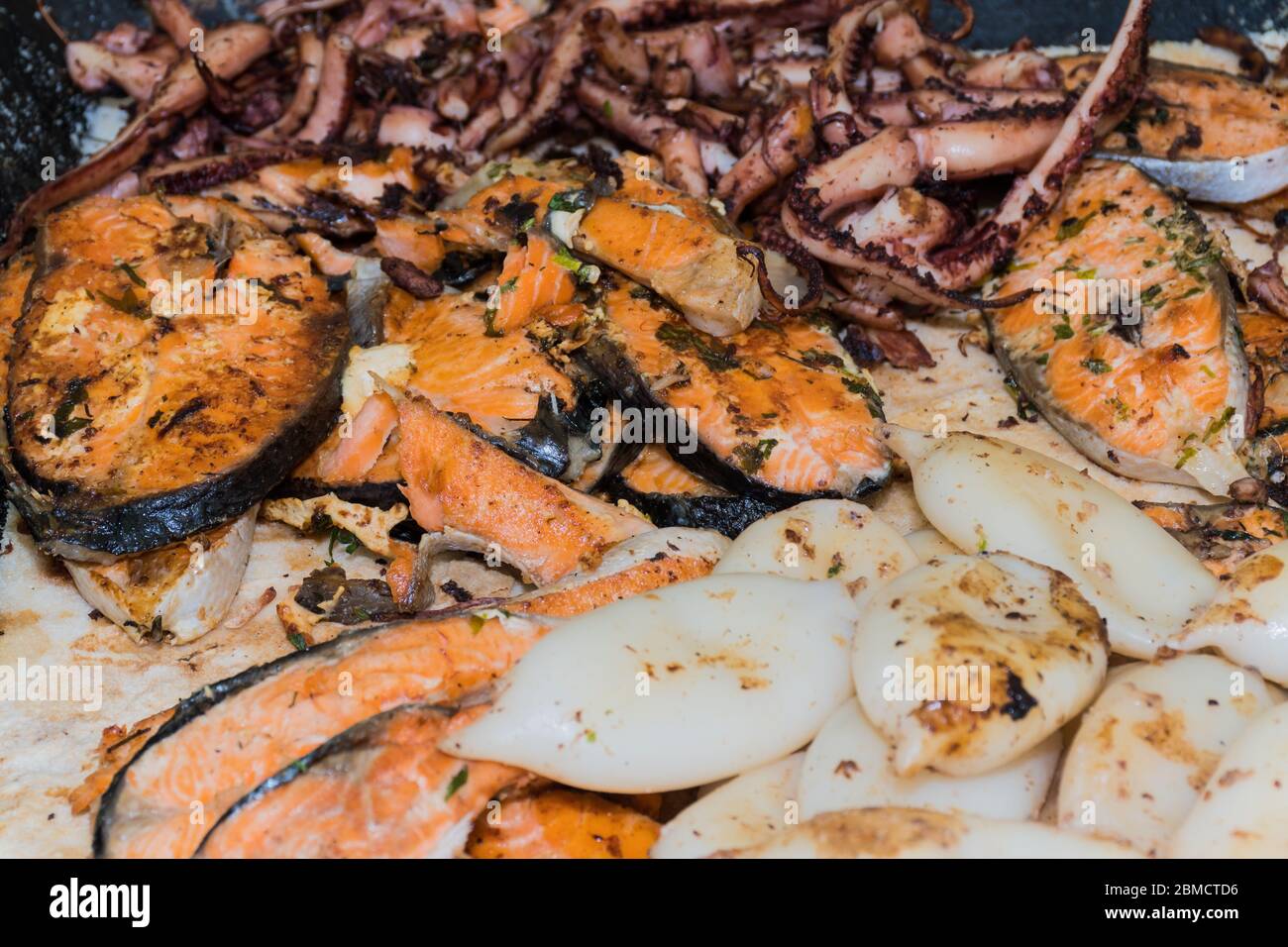 Fresh grilled seafood mix octopus, fish, squid, shrimp during hotel ...