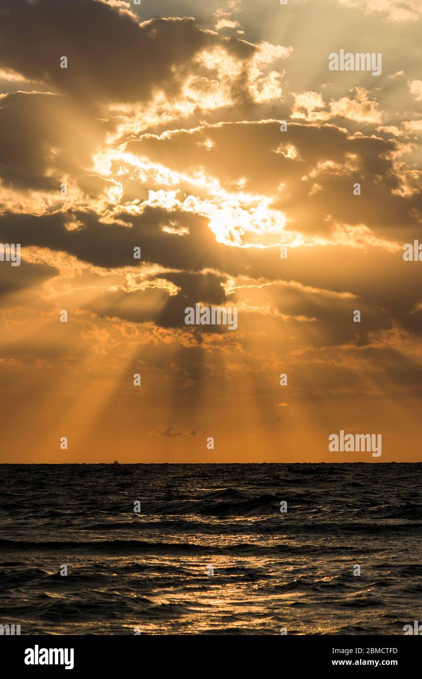 Golden hour of sunset at red sea shore with dramatic sky and the golden ...