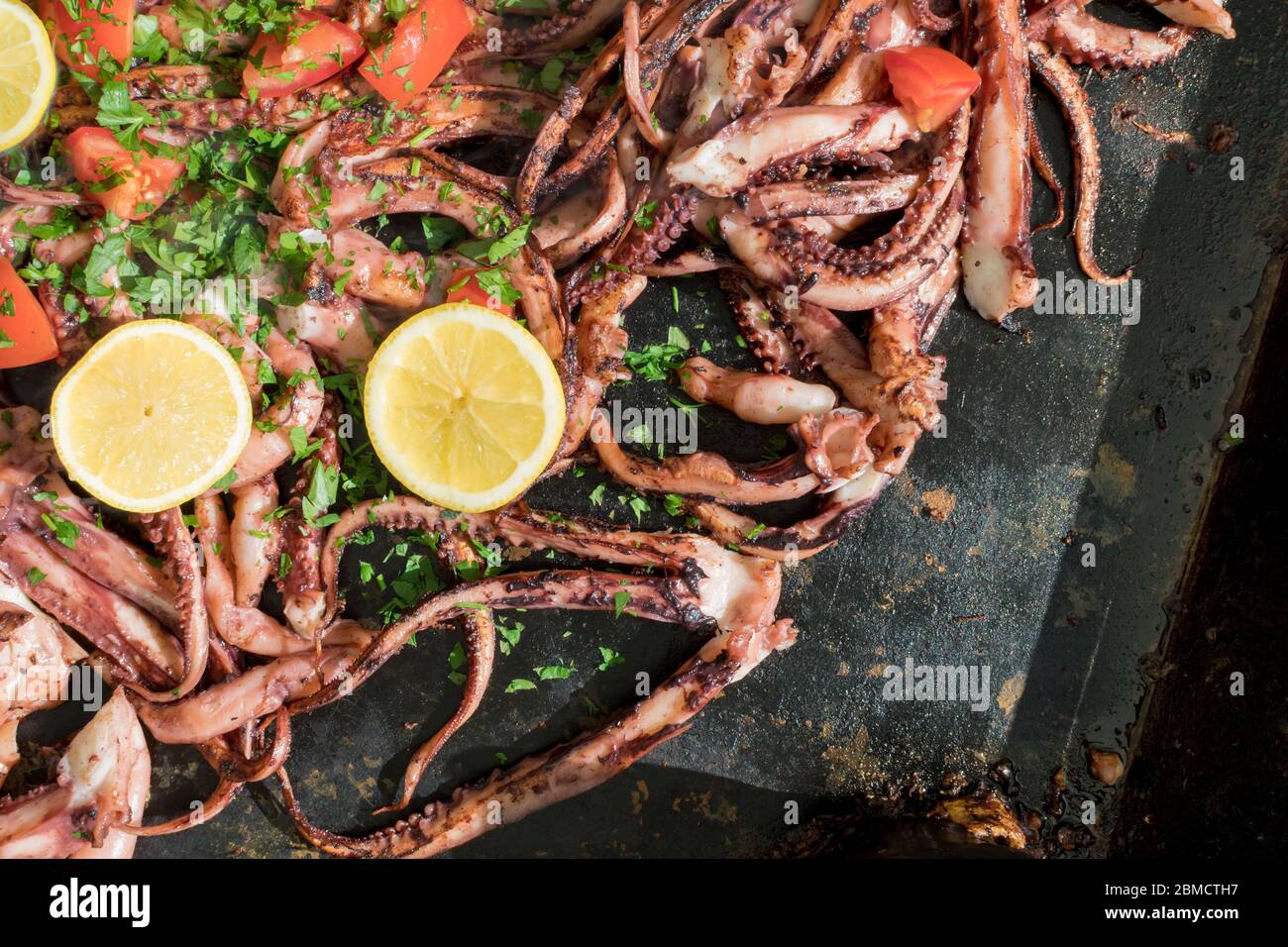 Fresh grilled seafood small baby octopus tentacles during hotel brunch ...