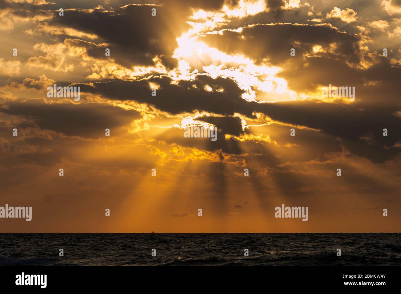 Golden hour of sunset at red sea shore with dramatic sky and the golden ...