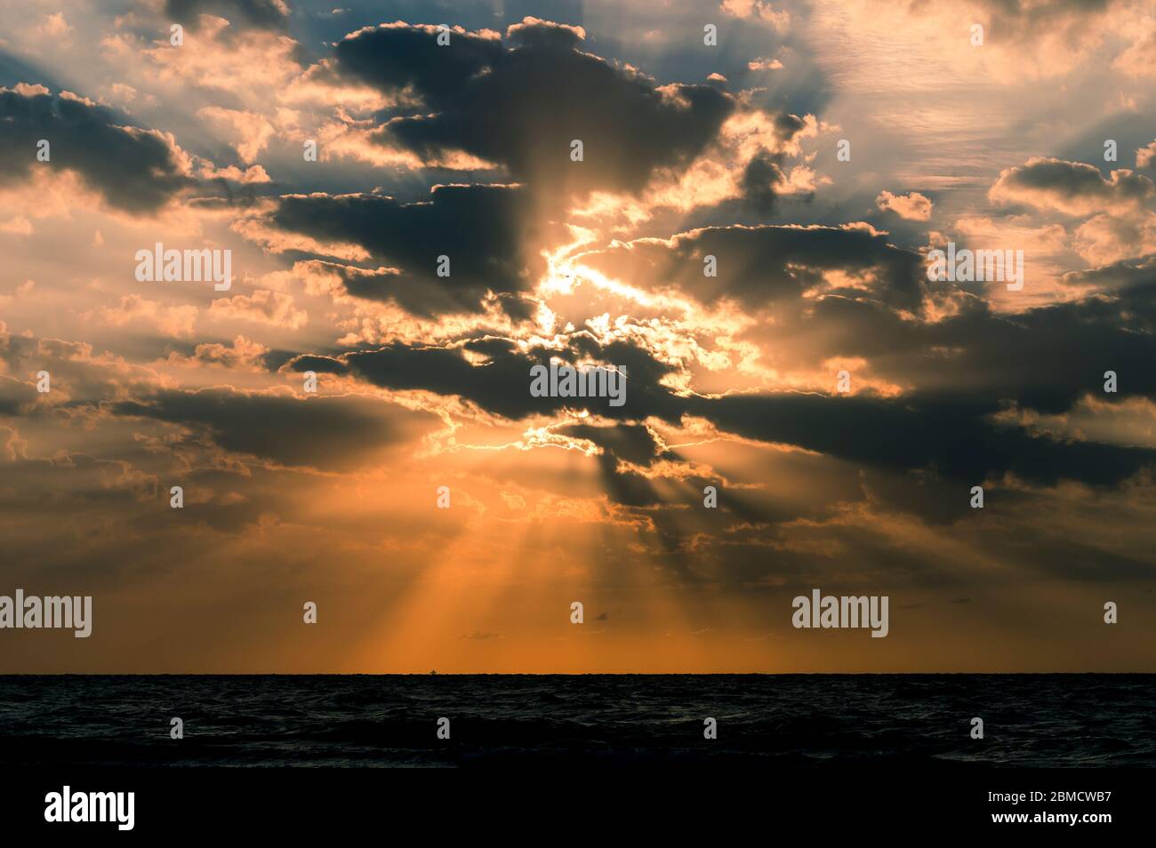 Golden hour of sunset at red sea shore with dramatic sky and the golden ...