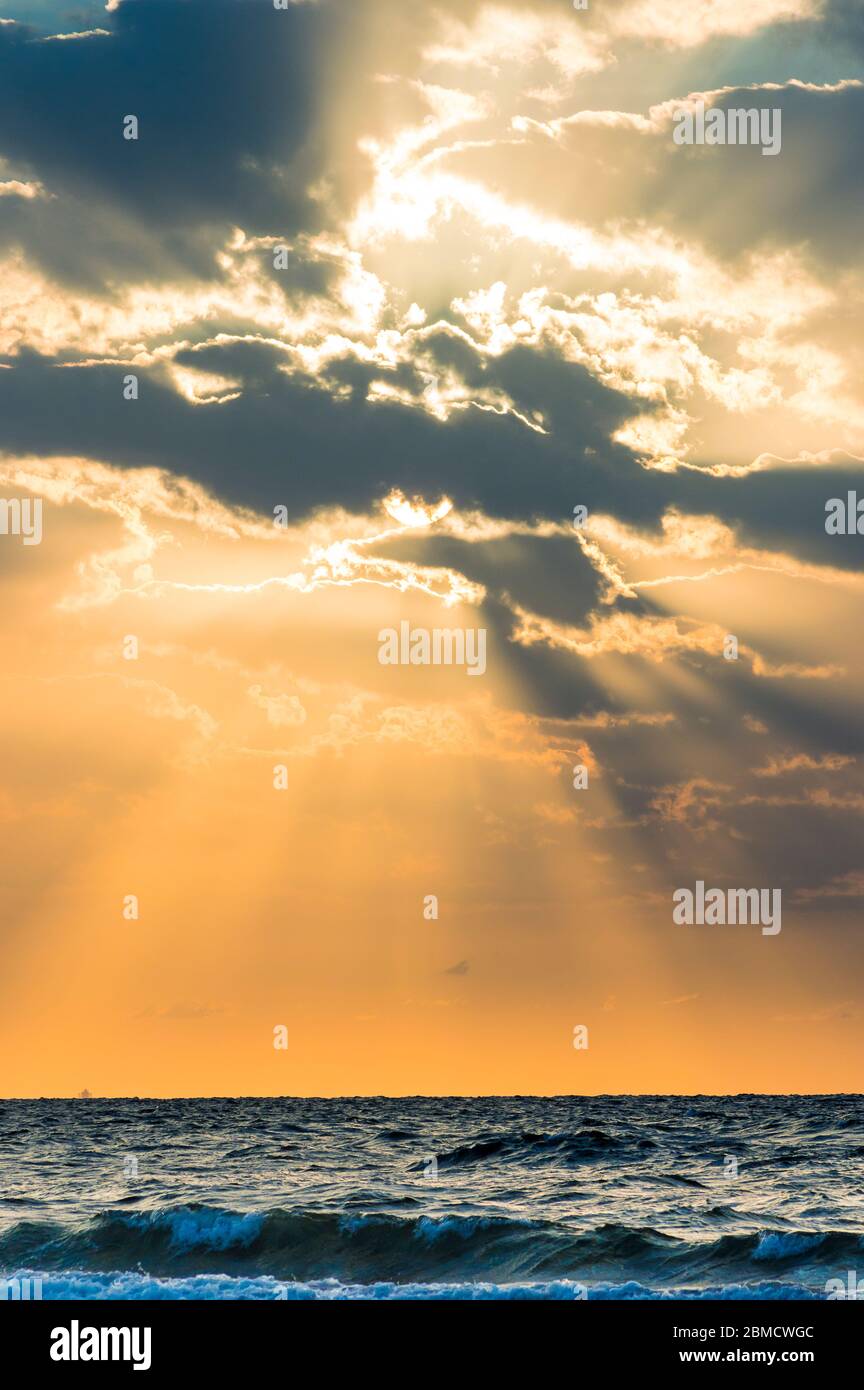Golden hour of sunset at red sea shore with dramatic sky and the golden ...