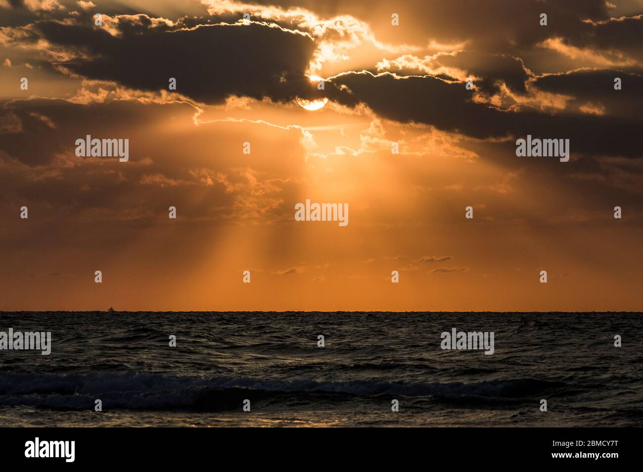 Golden hour of sunset at red sea shore with dramatic sky and the golden ...