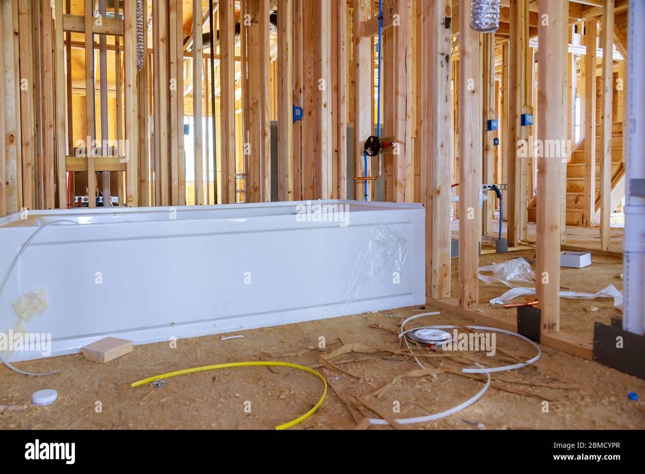 Interior framing of bathroom a new acrylic bathtub with a wood frame ...