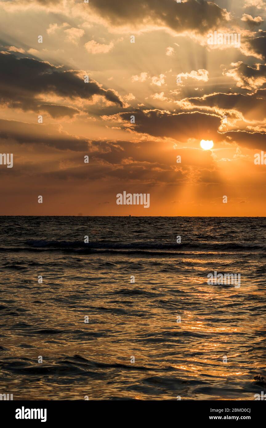 Golden hour of sunset at red sea shore with dramatic sky and the golden ...
